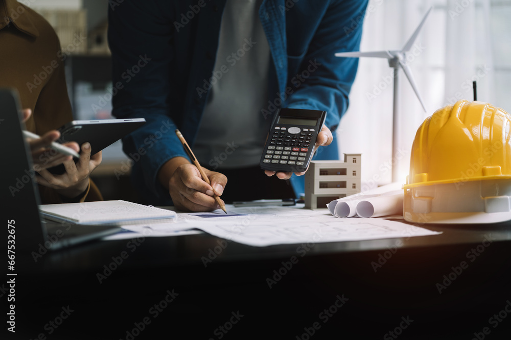 brainstorming and measuring for cost estimating on paperworks and floor ...