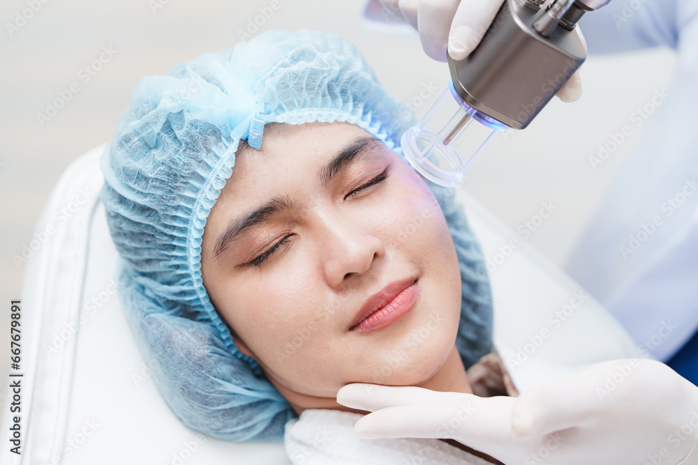 Side view of asian woman getting resurfacing laser fraxel dual and ...