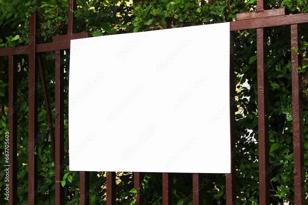 Blank billboard sign mockup on a fence in the urban environment, empty ...