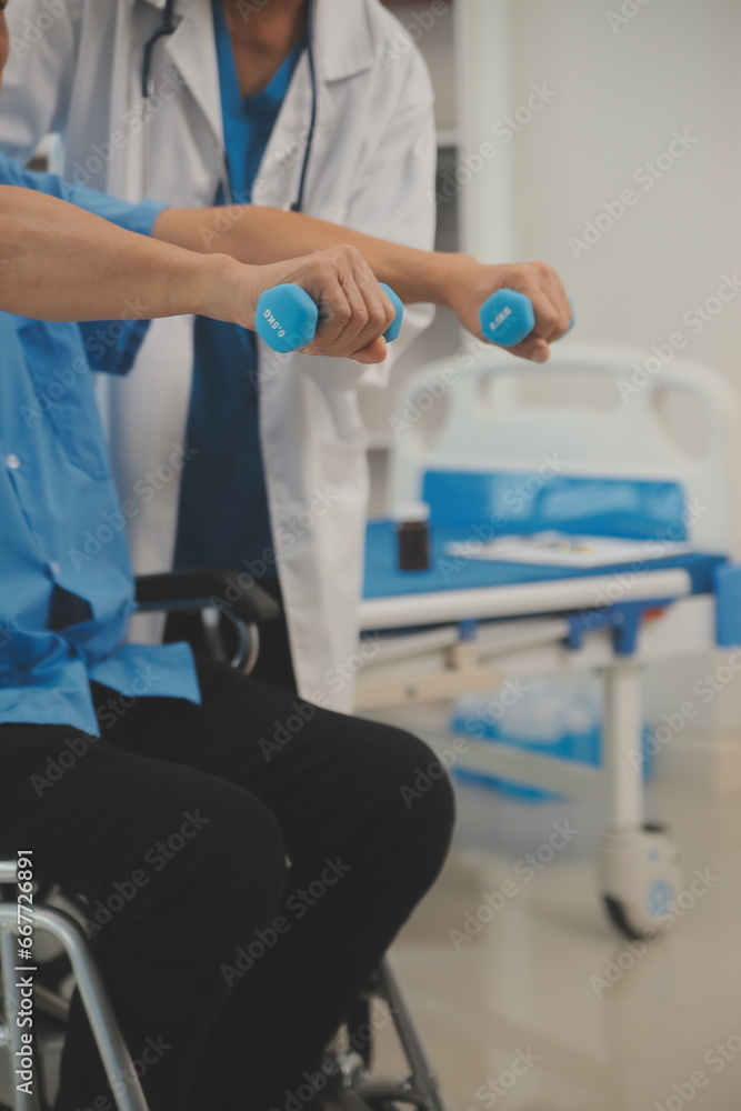 Asian older aged man doing physiotherapist with support from nurse ...