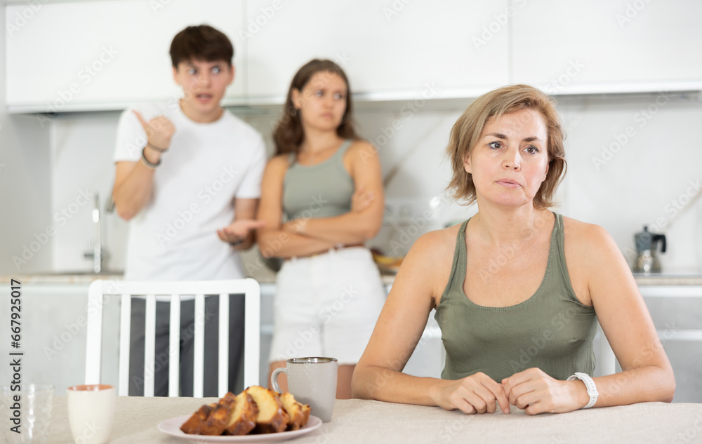 Adult children guy and girl are fighting with woman mother. Family ...