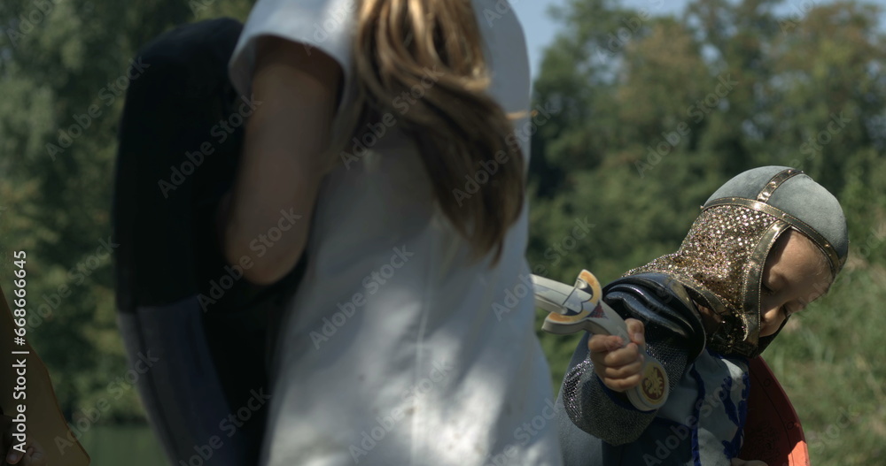 Children playing with swords and shields - young boy wearing medieval ...