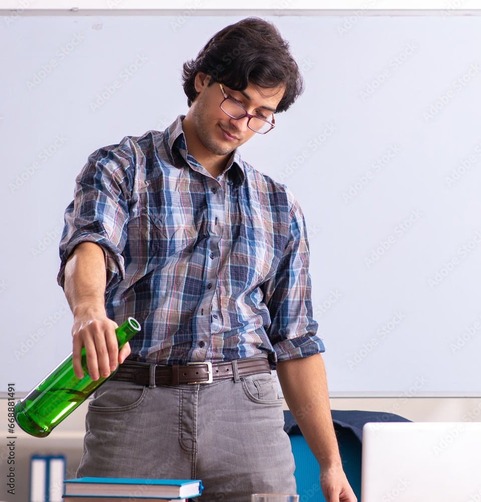 Male teacher drinking in the classroom Stock Photo | Adobe Stock