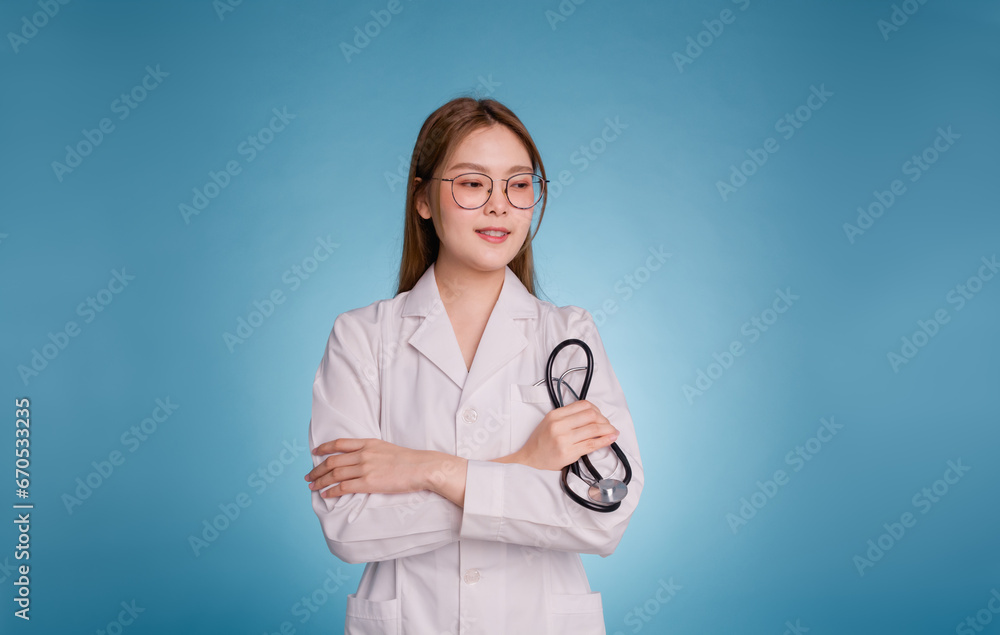 Portrait of smiling female doctor posing with arms crossed and ...