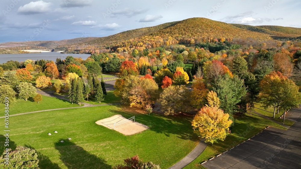 Mountain, trees and fields in sunny landscape with campground and ...