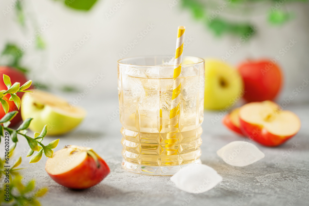Apple juice and sparkling water in glass. Apfelschorle German drink ...