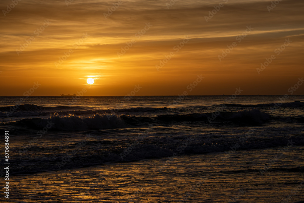 Sunrise over the Mediterranean in Miramar, Spain, with a ship visible ...