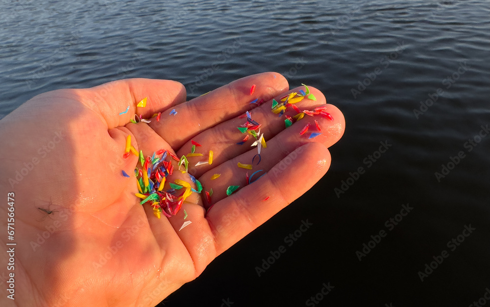 Microplastics on hand from lake. Micro waste in water fauna ...