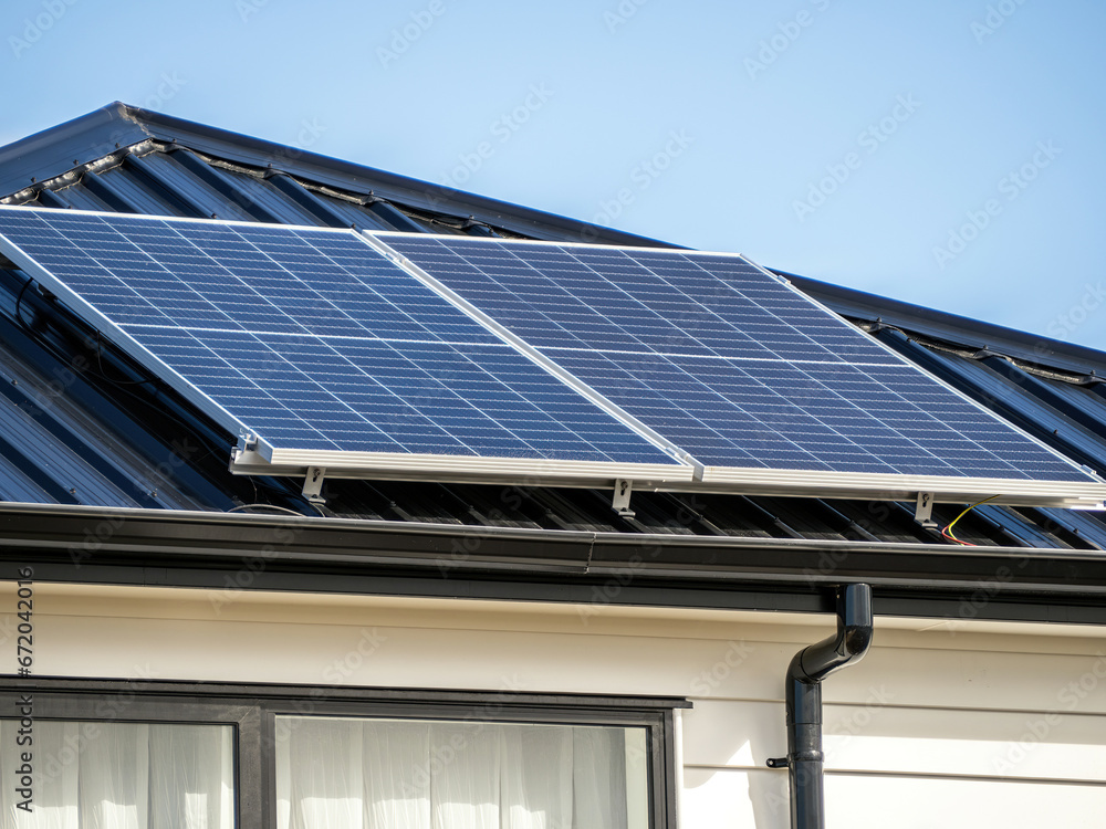 Solar panels on concrete tile roof of residential house with white ...