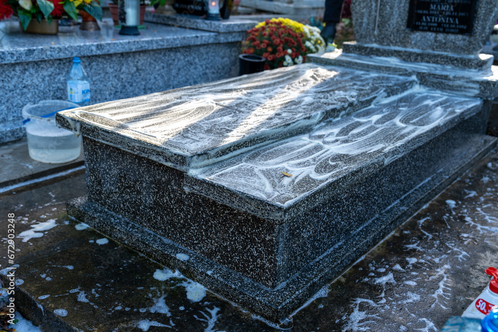 Preparing a grave for All Saints' Day celebrated on November 1st, a ...
