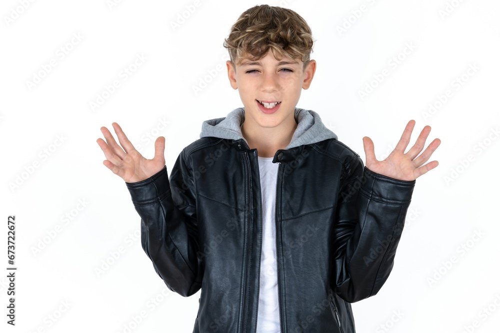 Crazy outraged caucasian kid boy wearing black jacket screams loudly ...
