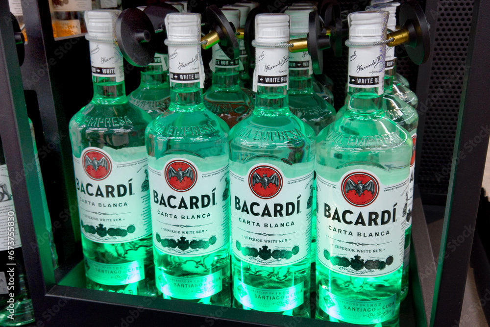 Bacardi rum for sale at a hypermarket. Display with light illumination ...