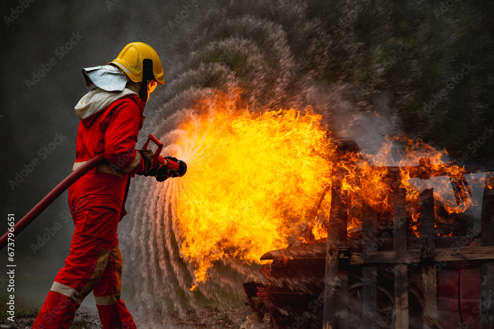 Burning car, Fireman water spray by high pressure nozzle in fire ...