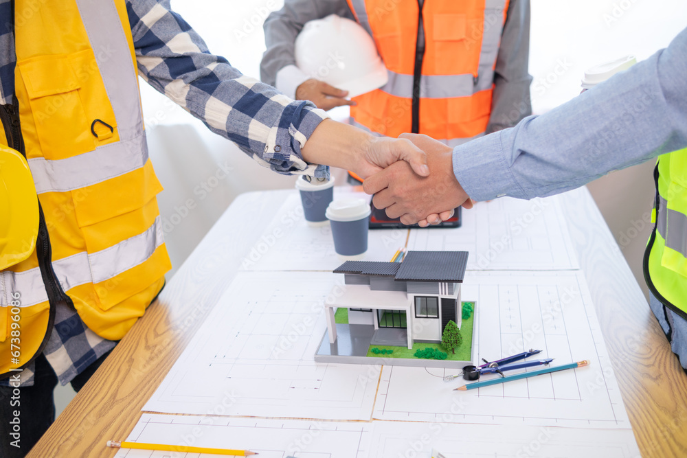 Architects and construction engineering handshake after meeting discuss ...