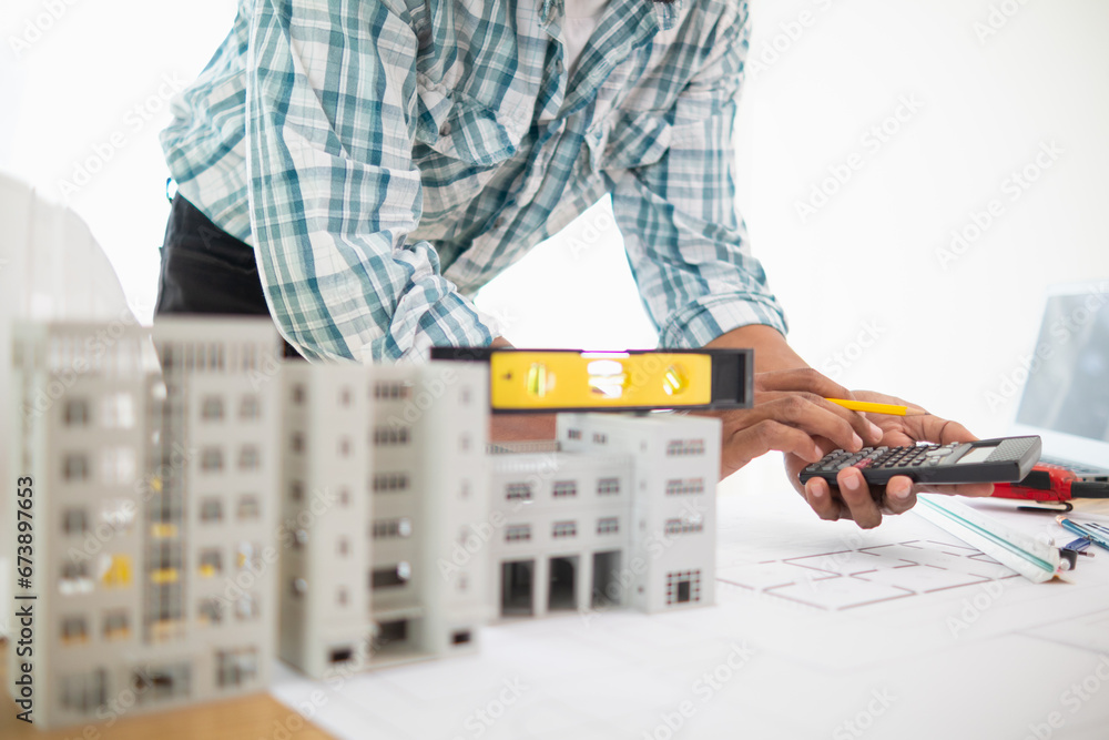 Construction engineers are checking blueprints and calculating their ...