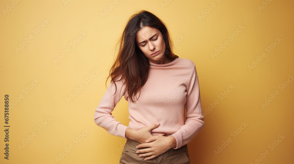 sad young woman holding her stomach, illness, cramps, health, color ...