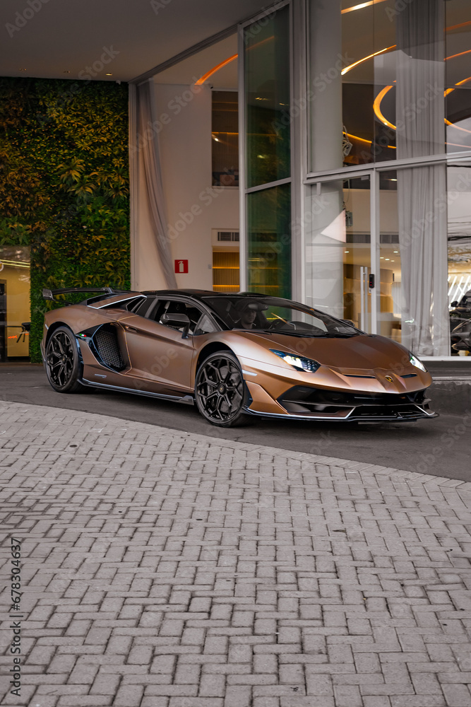 Golden Lamborghini Aventador SVJ Roadster front view three quarters ...