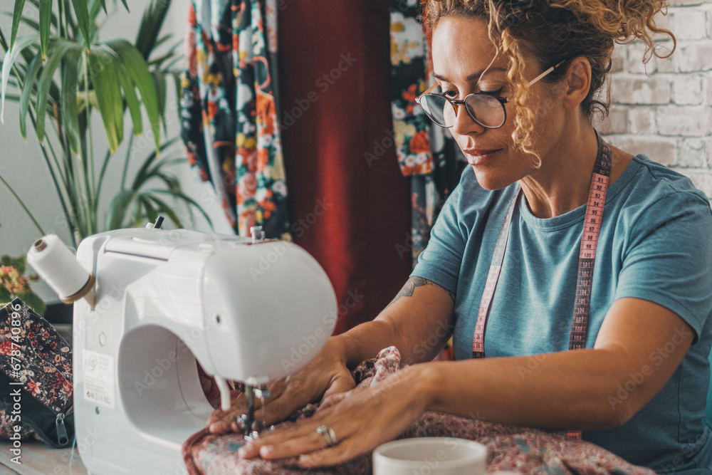 One worker woman at home or workshop using and working with sewing ...