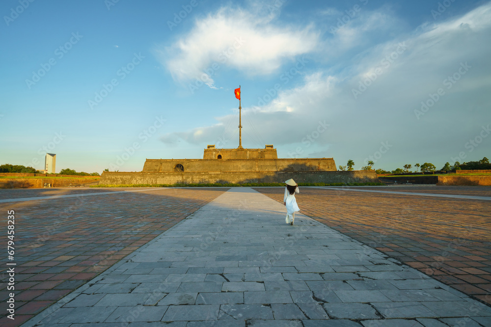 Ky Dai flag tower at Ngo Mon square with Vietnamese girl wearing ...