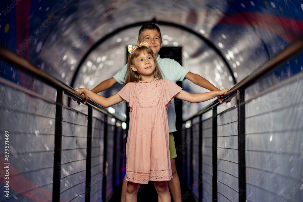 Little boy and girl in a room that shows the universe and gravity ...