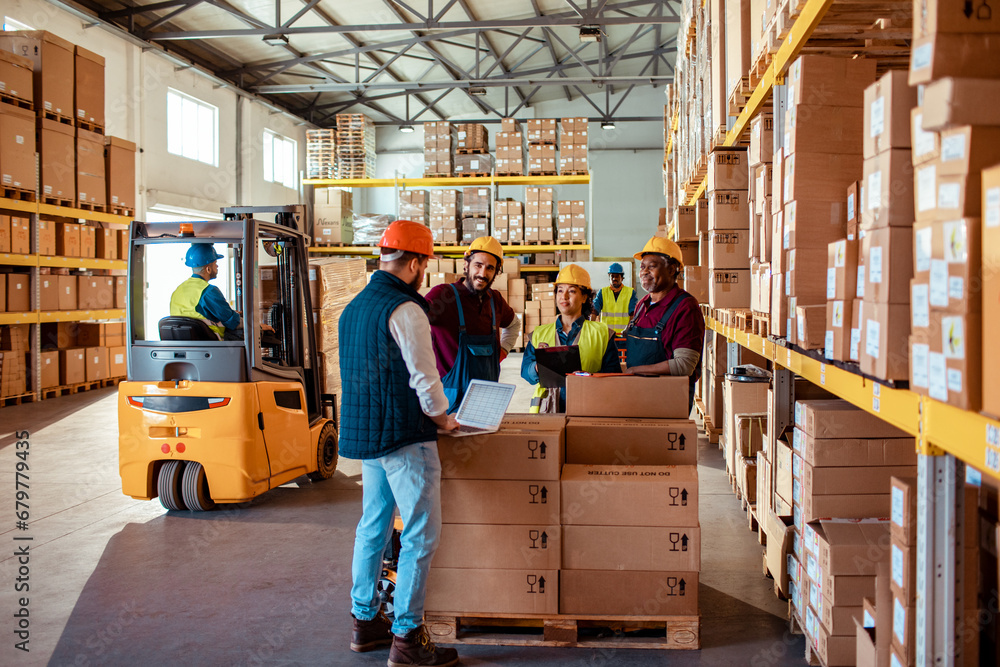 Professional warehouse worker team working together in a large ...