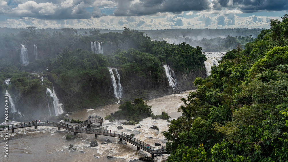 A pedestrian bridge for tourists is laid over the riverbed. Turbulent ...