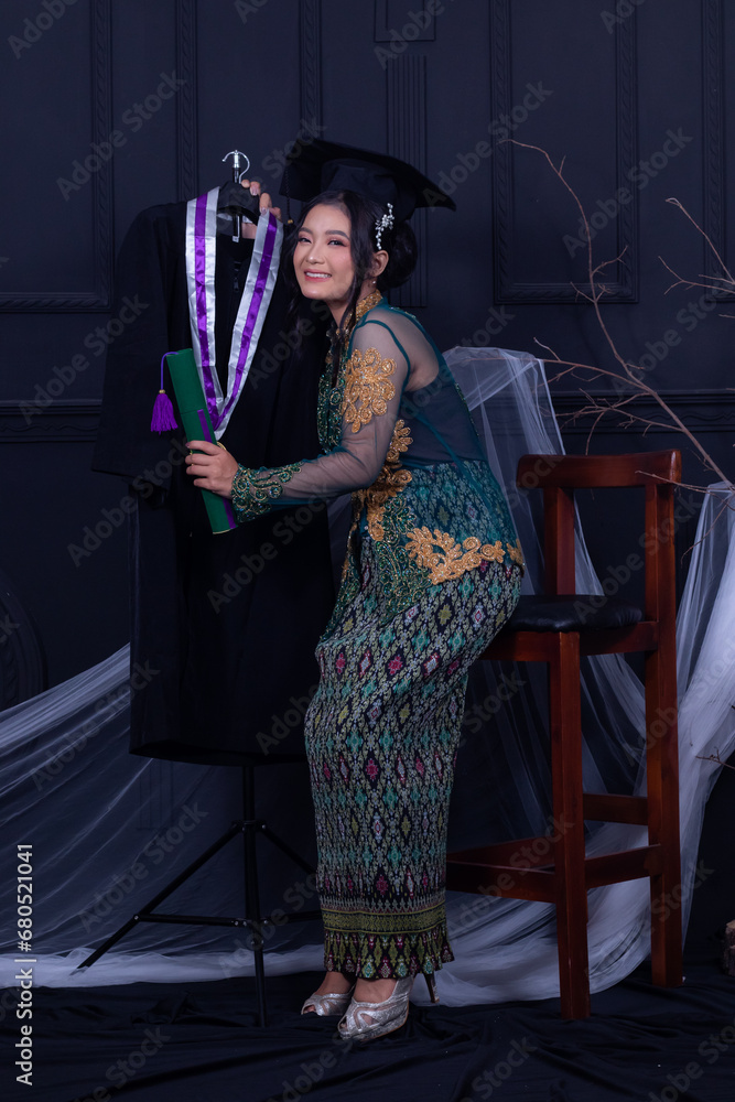 beautiful exotic Asian woman graduating smiling happily hugging her ...