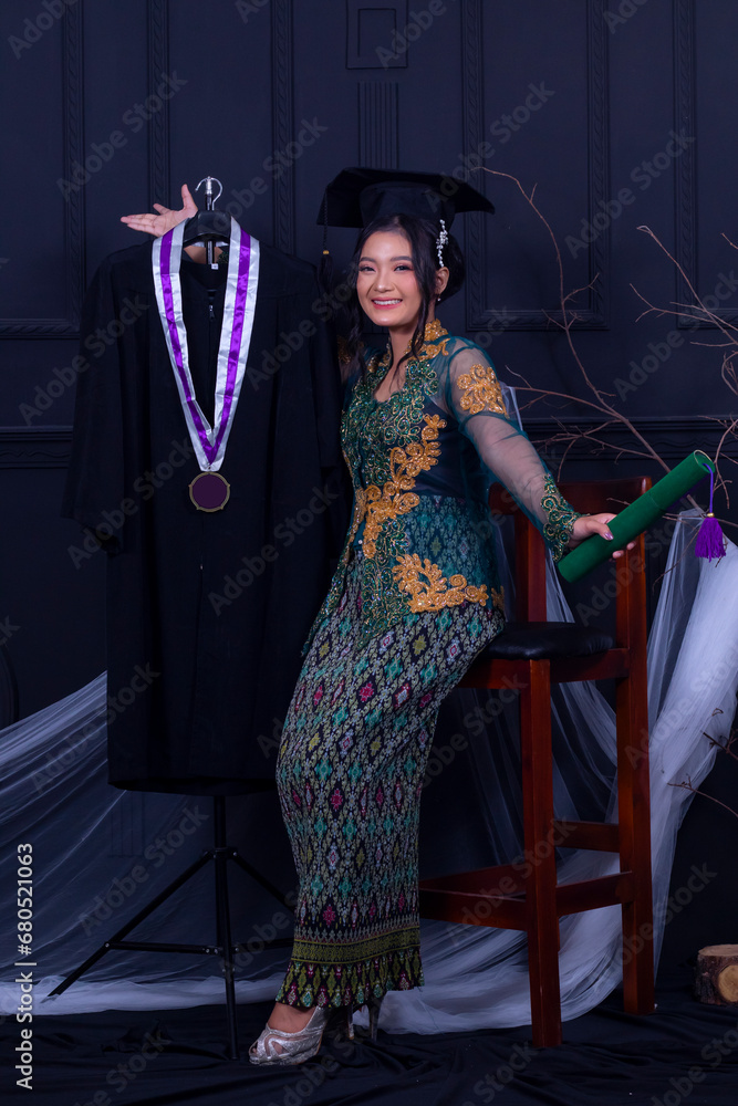 beautiful exotic Asian woman graduating smiling happily presenting ...