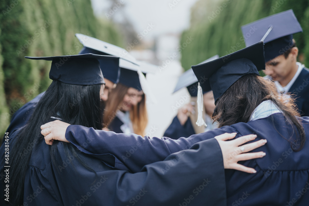 Graduating students celebrate their achievement, hugging and smiling in ...