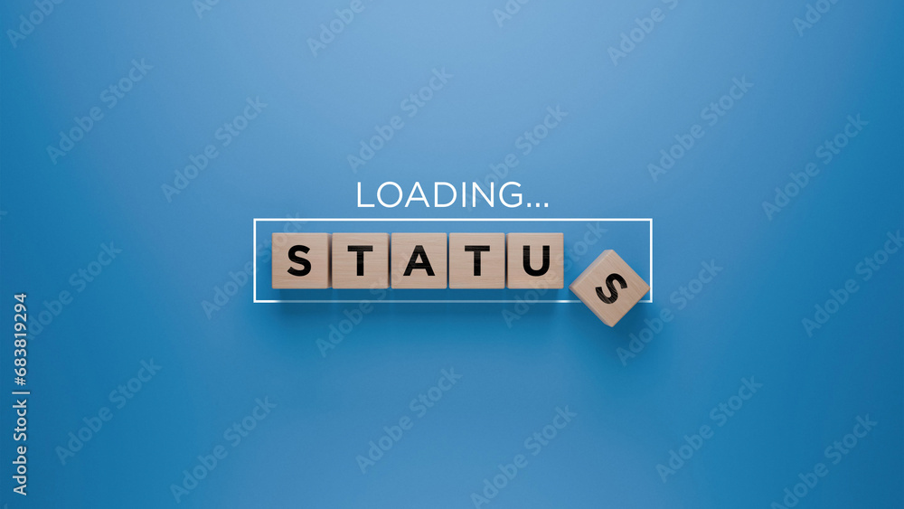 Wooden blocks spelling 'STATUS' with a loading progress bar on a blue ...