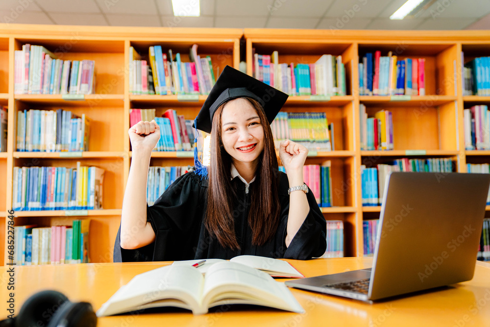 Excited Asian female university graduate celebrates successful ...