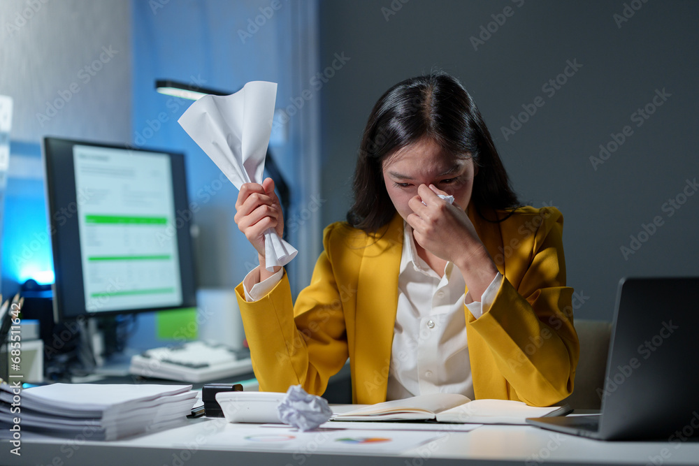 Asian businesswoman or female office worker who is angry, irritated, stressed over a failed job ...