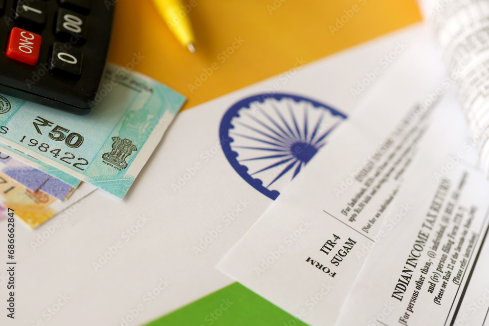 Indian income tax return blank form with pen and indian rupees bills on ...