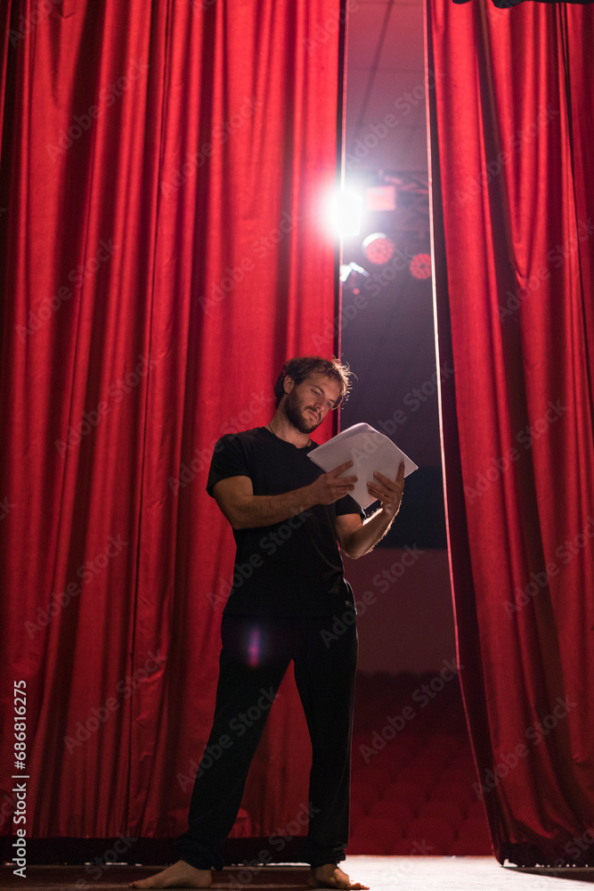 Barefoot actor standing on stage of theatre reading script Stock Photo ...