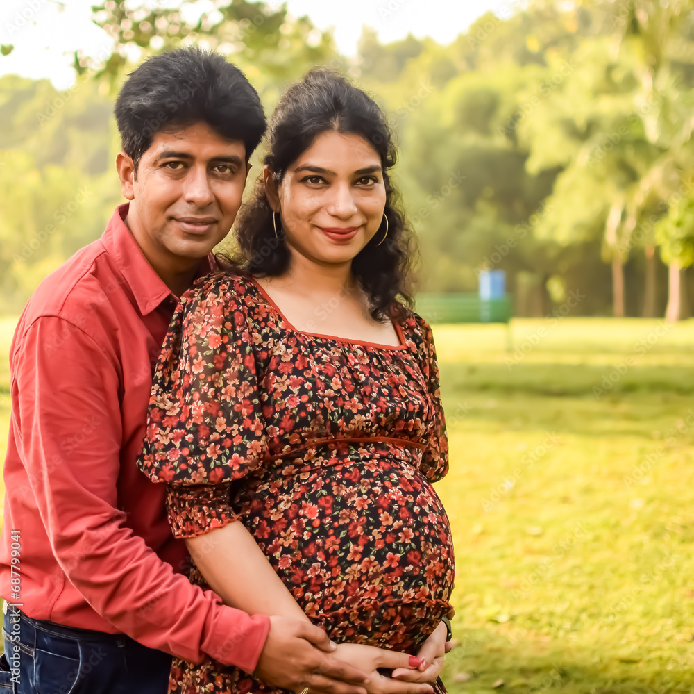 Indian couple posing for Maternity shoot pose for welcoming new born ...