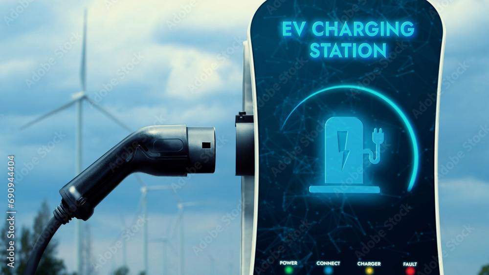 EV charger from EV car charging station in nature and wind turbine farm ...