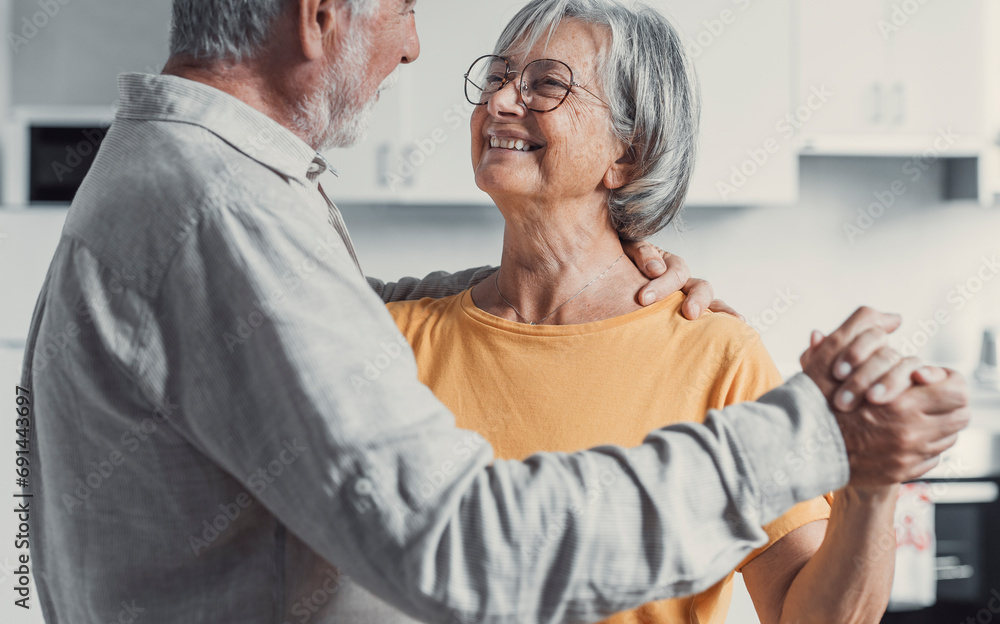 Joyful active old retired romantic couple dancing laughing in living ...
