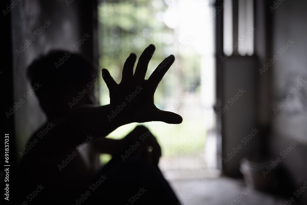 Child abuse concept, silhouette of child confined in a dark room ...