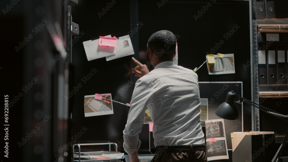 Foto de Stock Professional police officer hanging clues on wall map to ...