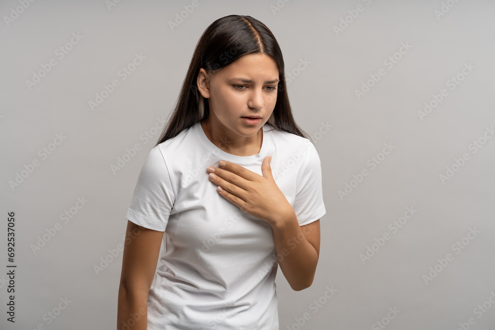 Sick unhealthy teenager feeling uncomfortable, touching chest ...
