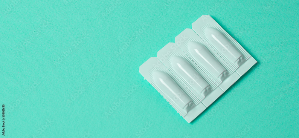 vaginal suppositories on mint background. Top view. Treatment of ...