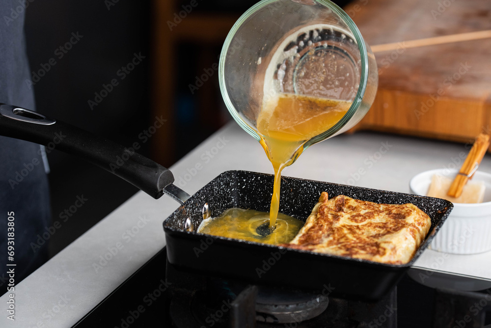 Chef man hands cooking Tamagoyaki or Tamago traditional Japanese Rolled ...