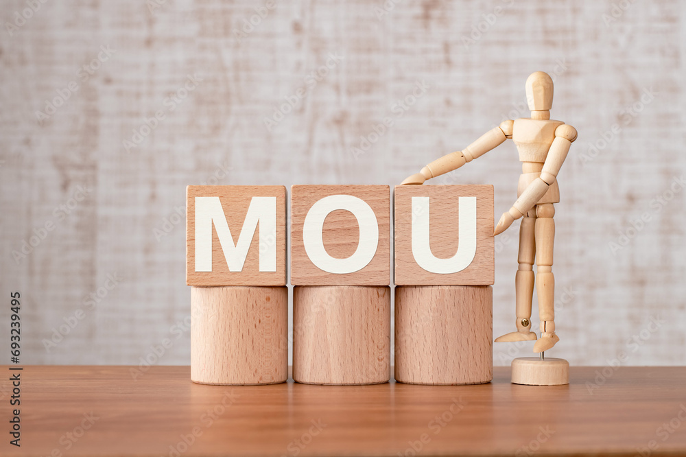 There is wood cube with the word MOU. It is an abbreviation for ...