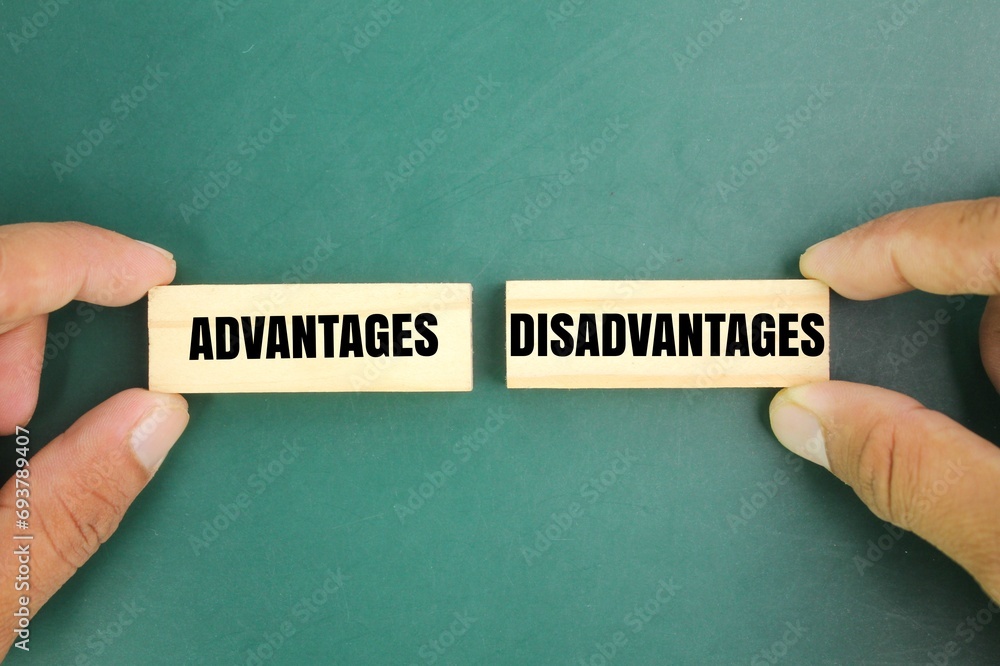 hand holding a stick with the words Advantages and Disadvantages. the ...