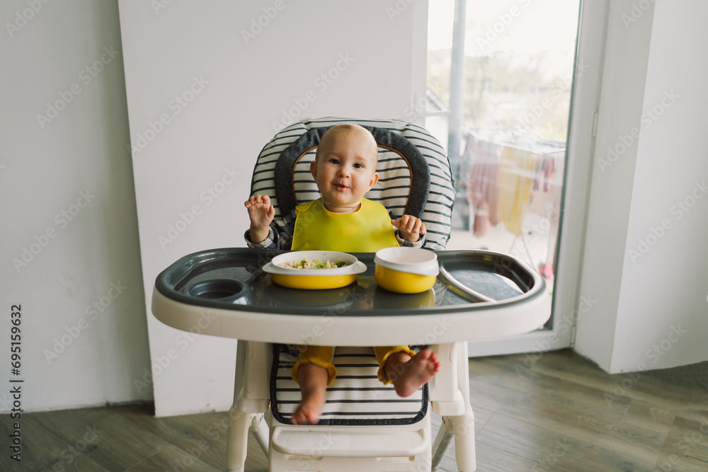 Little child with solid nutrition. Baby girl eating finger food and mix ...