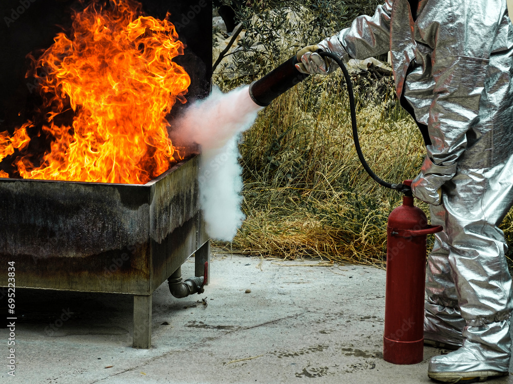 stcw firefighting prevention training, man using fire extinguisher ...