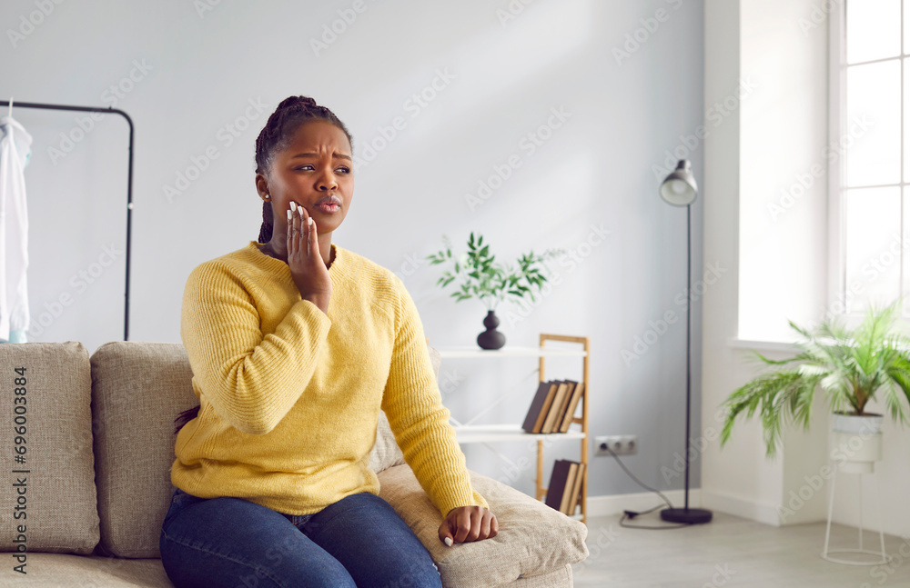 Upset young beautiful african american woman is suffering from ...