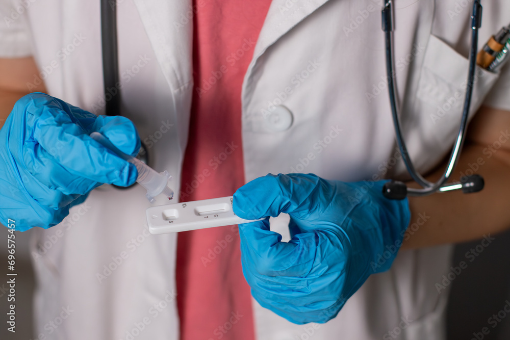 Doctor in a hospital using rapid antigen test kit for self test COVID ...