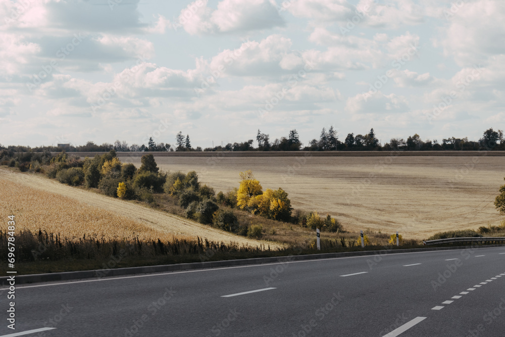An image of a large field with wheat growing. The clear sky is covered ...