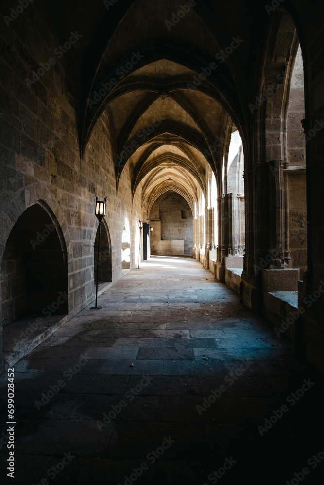 Interior corridor in ancient landmark building with gothic arch in a ...